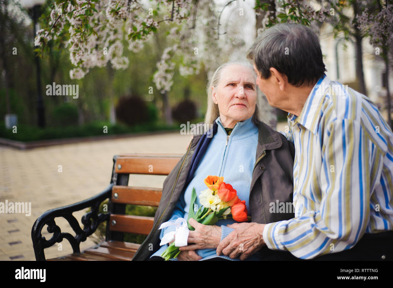 Beautiful happy old people sitting in the autumn park Stock Photo - Alamy
