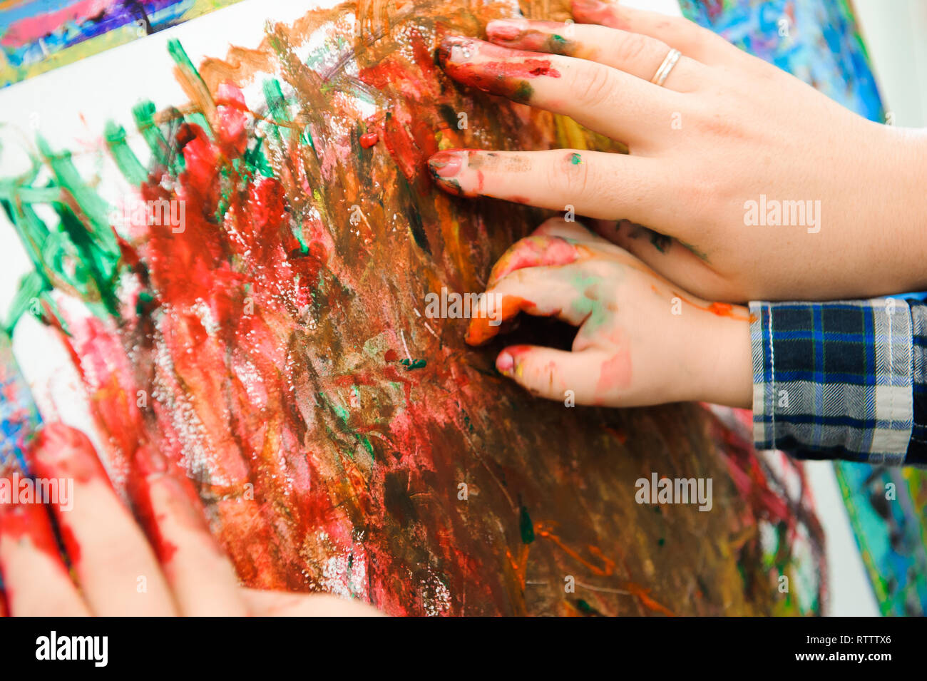 Mother and child draw a picture paints, art lesson Stock Photo - Alamy