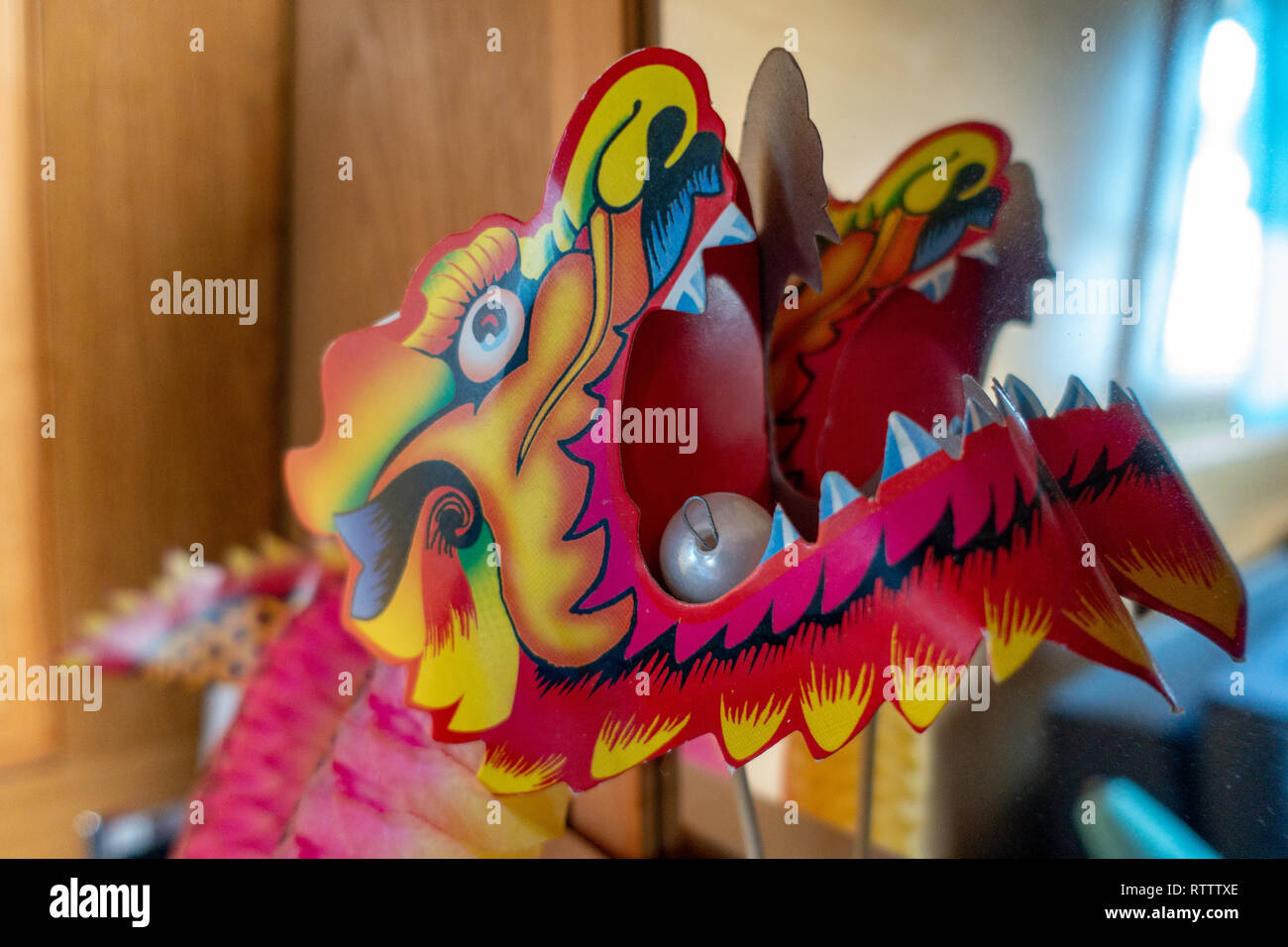 Closeup of colourful Origami paper dragons head with open mouth and ...