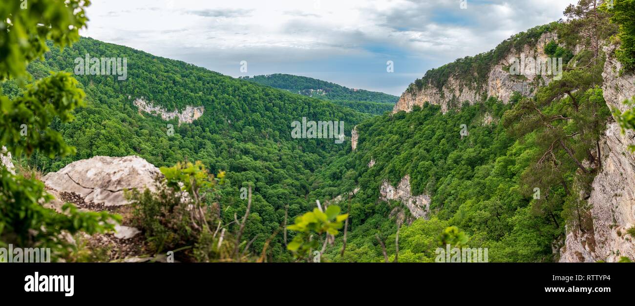 Panoramic view of the mountain with a steep rocky slope and valley with ...