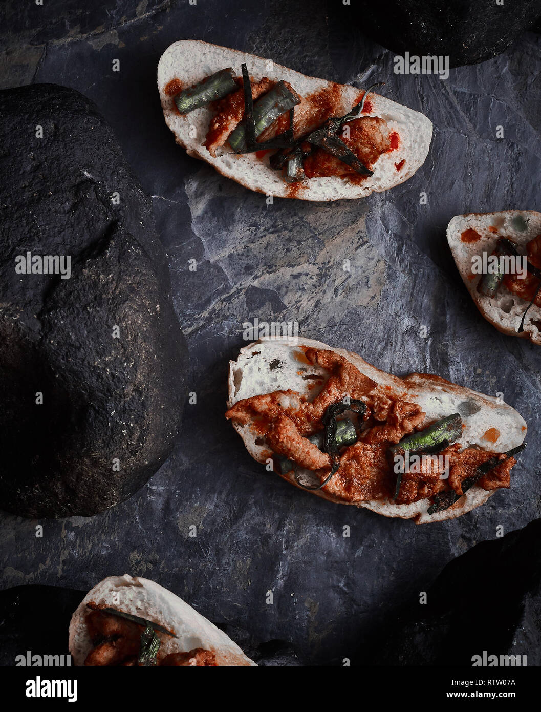 Spicy stir fried pork with red curry paste canapes Stock Photo - Alamy