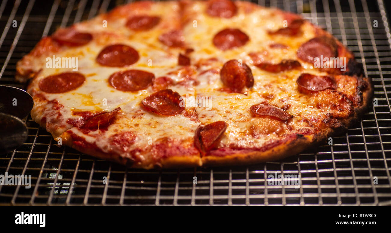 A Pepperoni Pizza baking to golden brown in Oven Stock Photo - Alamy