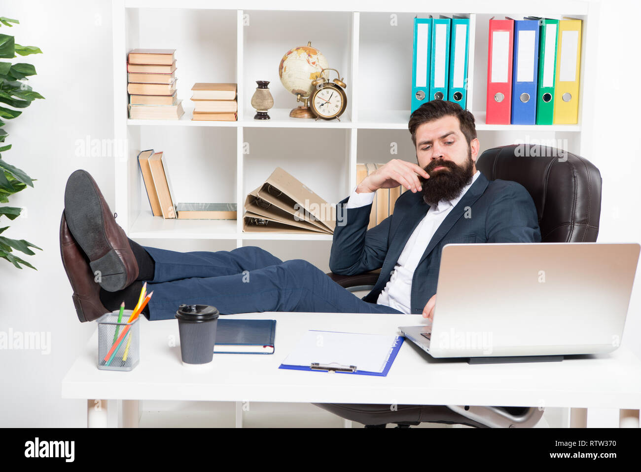 Done enough for today. Man bearded hipster boss sit in leather armchair ...