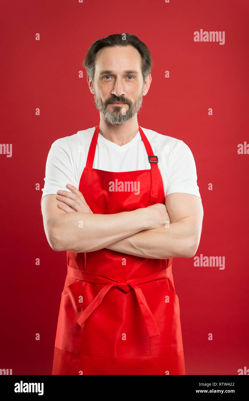 Confident in his culinary craft. Cook with beard and mustache wearing ...