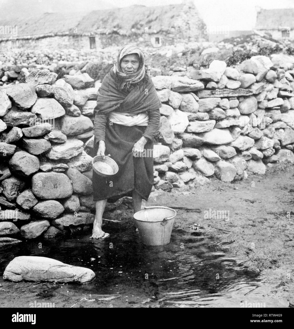 irish peasant woman collecting water in the west coast of ireland circa ...