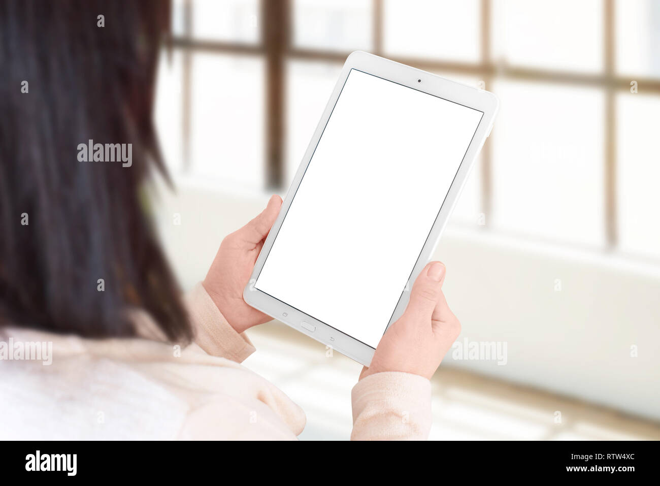 White tablet with isolated screen for mockup in woman hand. Vertical ...