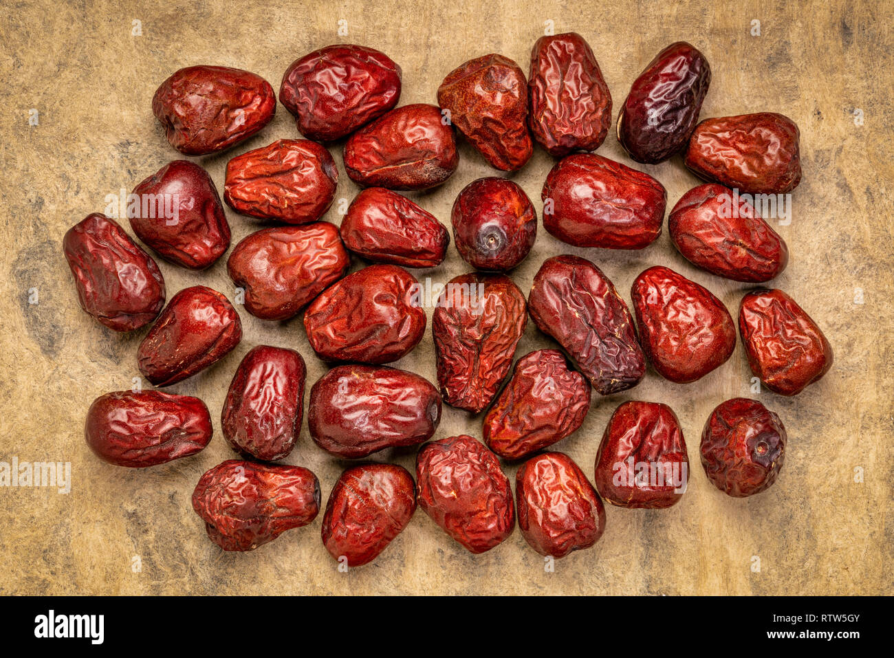 dried jujube fruits on textured bark paper, top view Stock Photo - Alamy