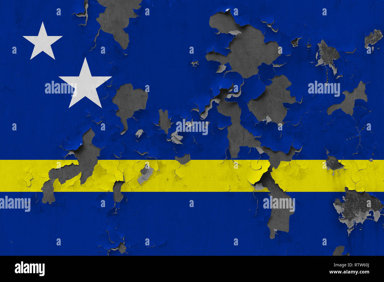 Close up grungy, damaged and weathered Curacao flag on wall peeling off ...