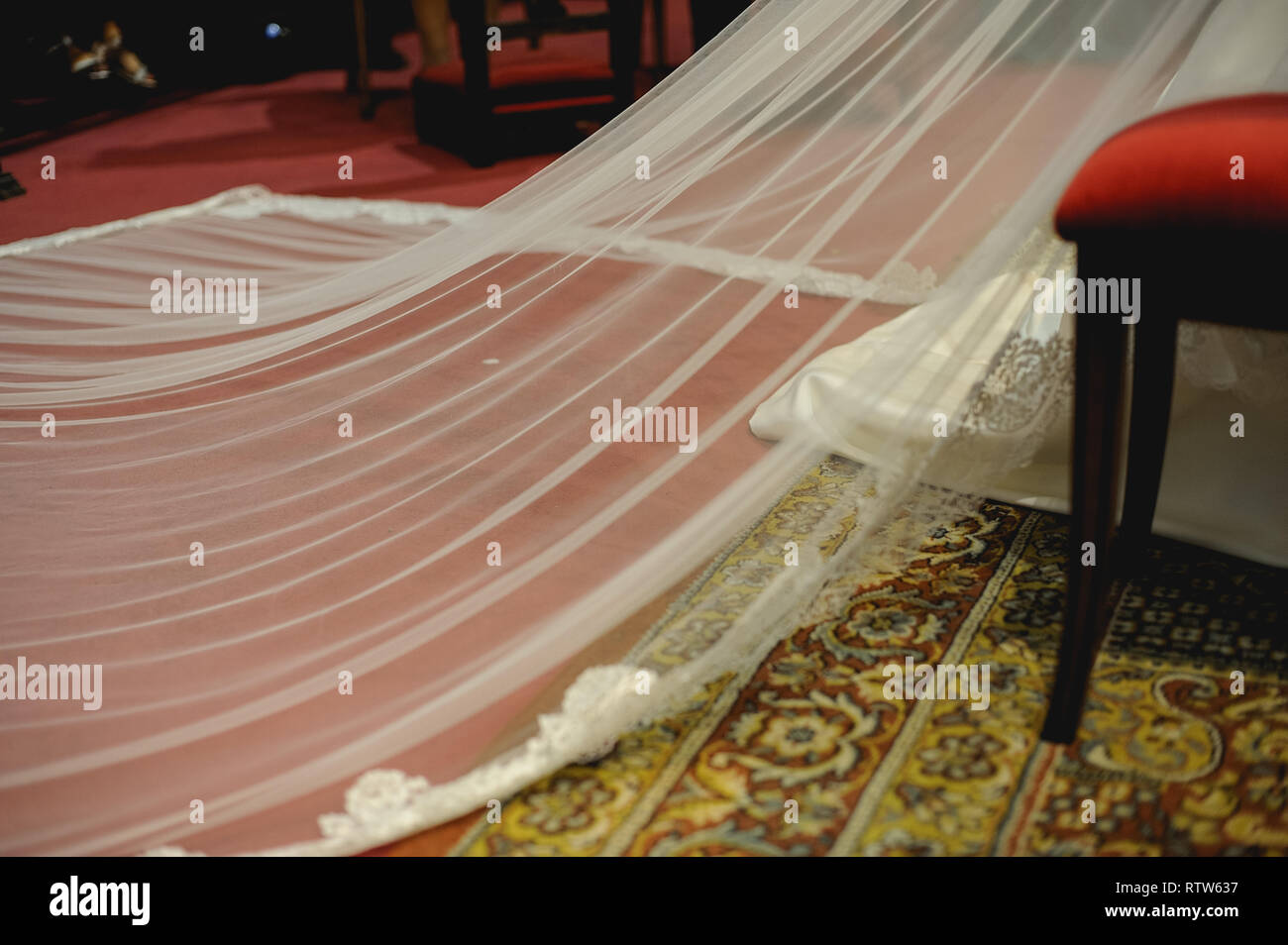 tail of wedding dress on red carpet Stock Photo - Alamy