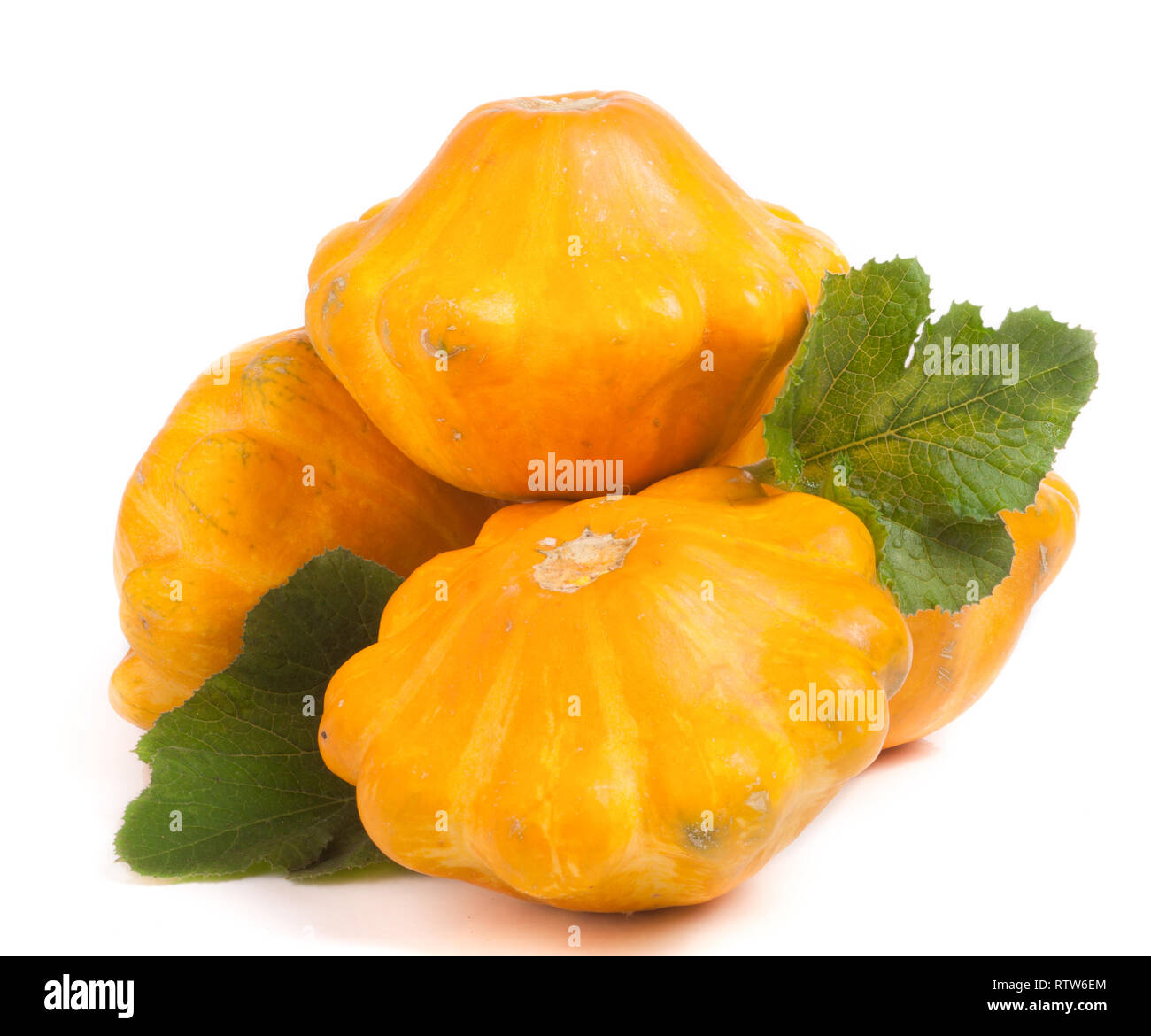 four yellow pattypan squash with leaf isolated on white background ...