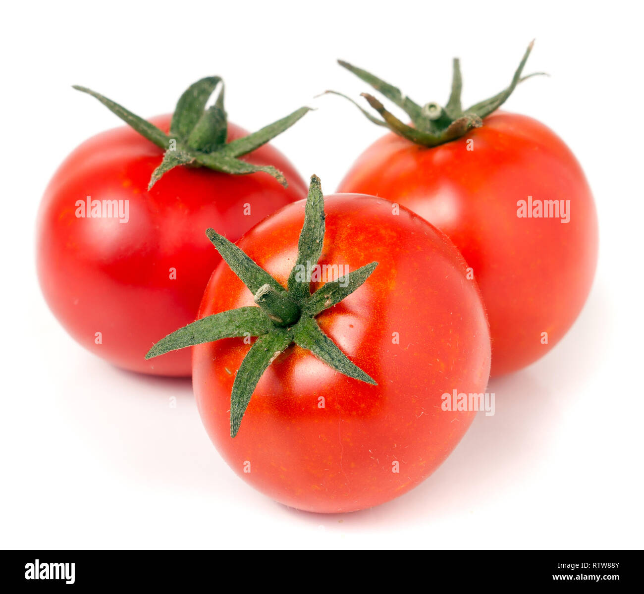 three tomato isolated on a white background Stock Photo - Alamy