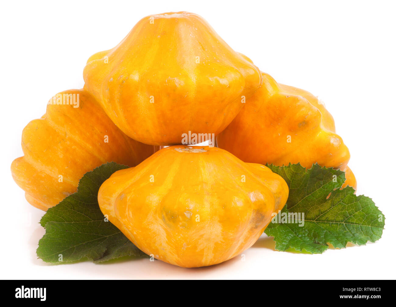 four yellow pattypan squash with leaf isolated on white background ...