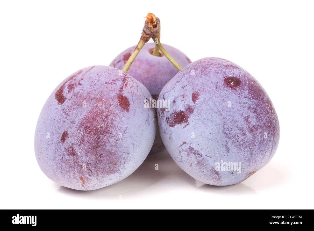 three plums isolated on white background Stock Photo - Alamy