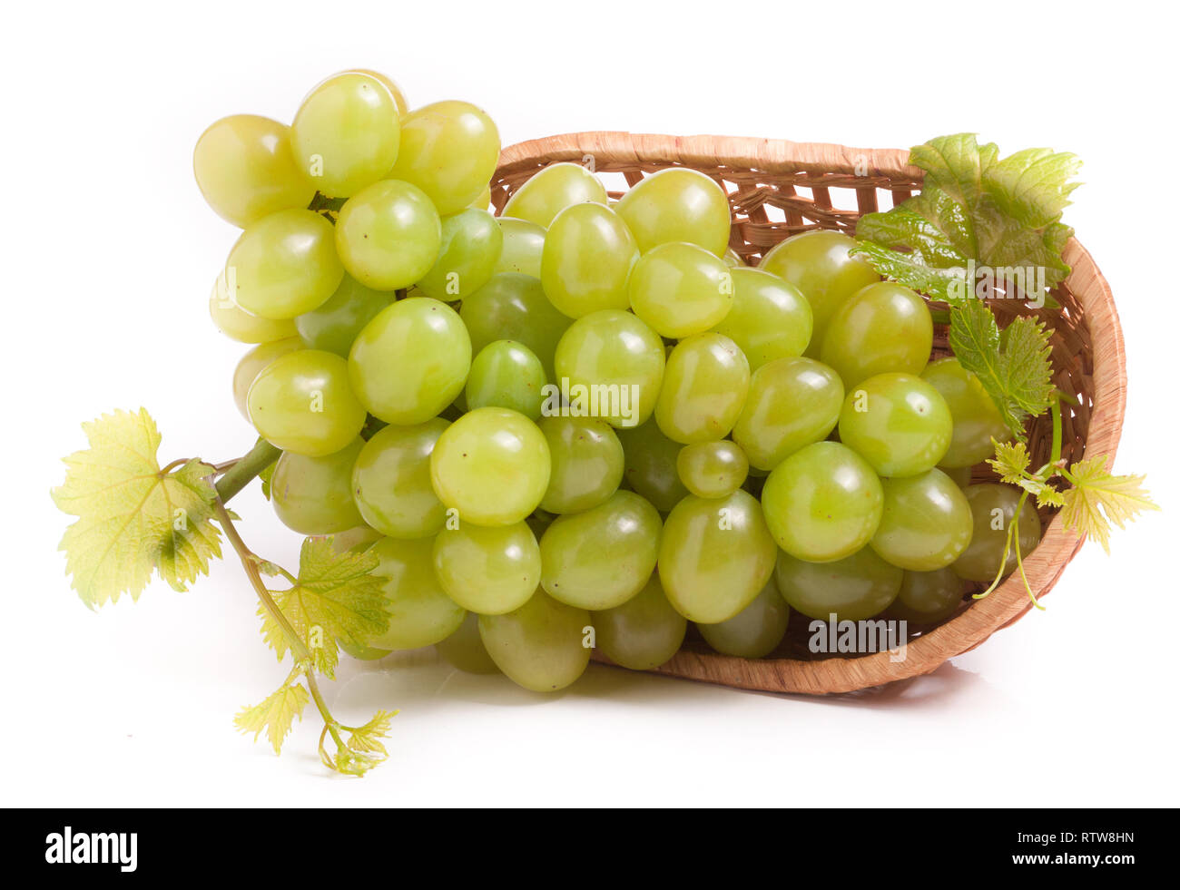green grapes in a wicker basket isolated on white background Stock ...