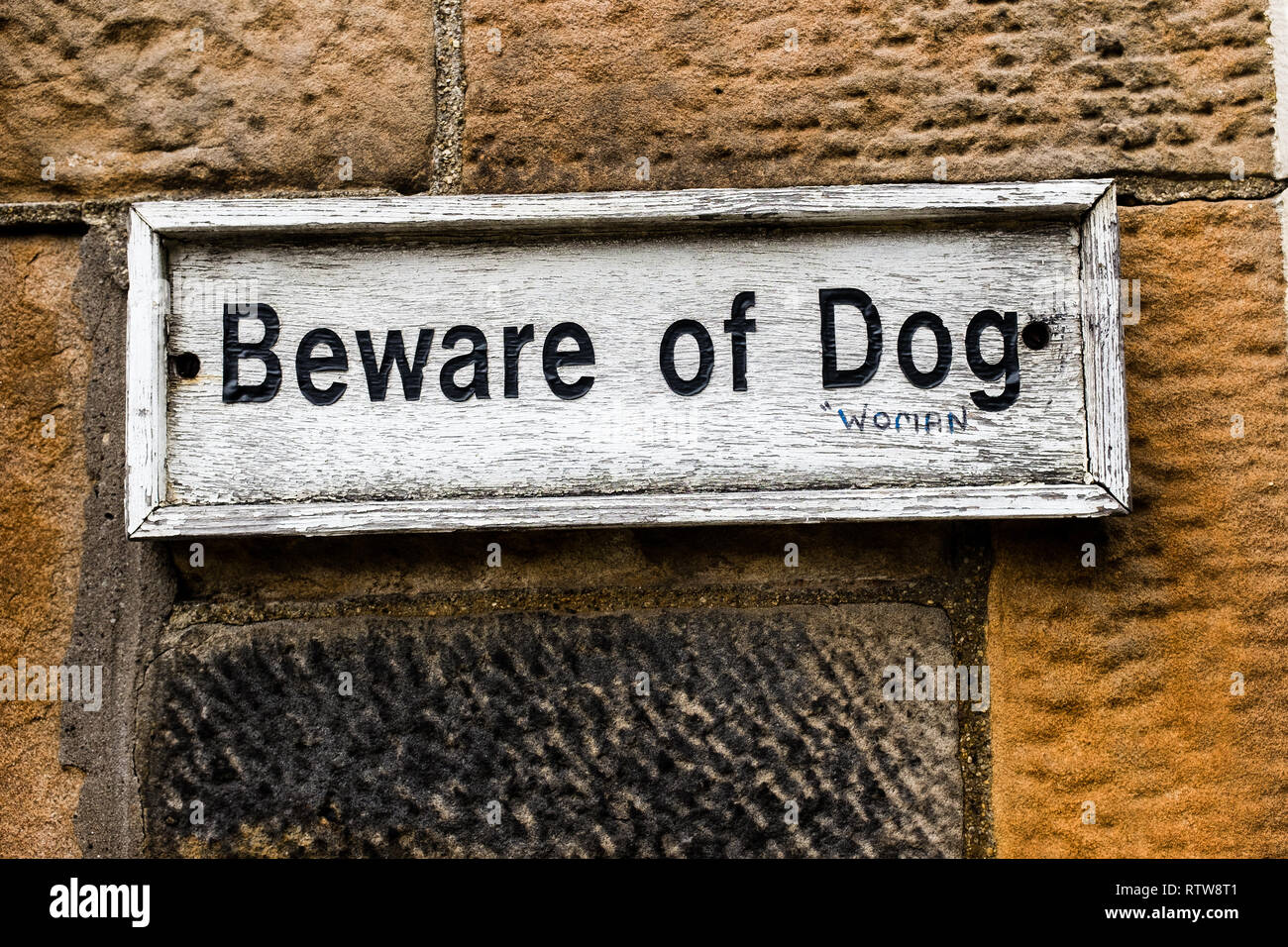 A humorous take on a beware of dog sign with extra text added .Beware ...