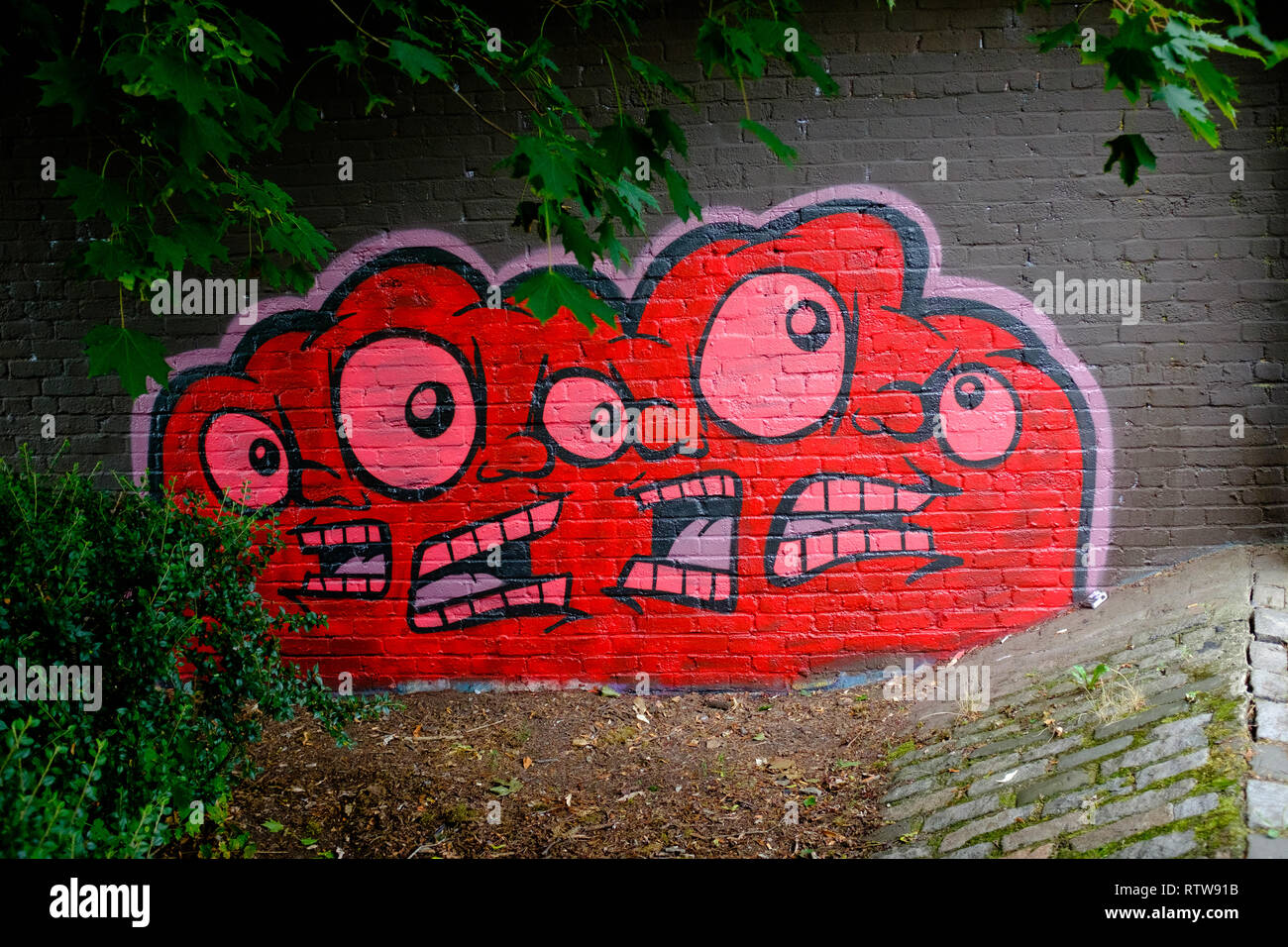 Bright red graffiti sprayed on wall of Kelvinbridge Glasgow underground ...