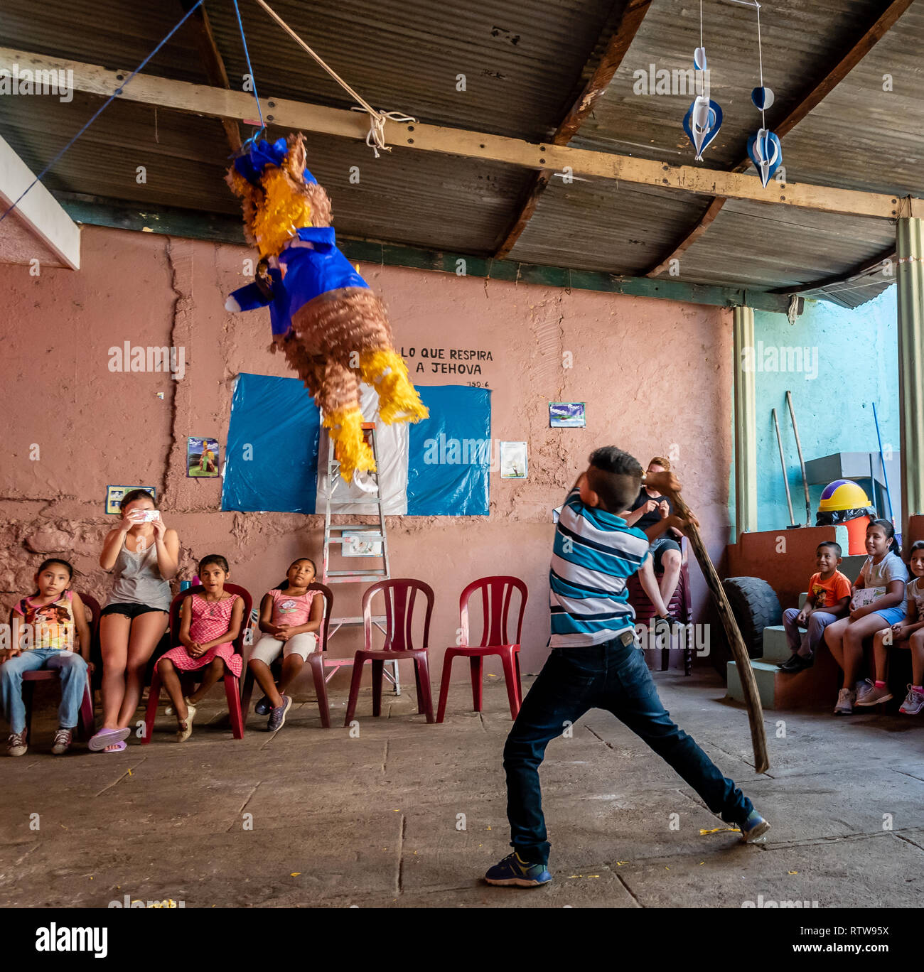 young latin boy swinging at pinata at Guatemalan birthday party Stock ...