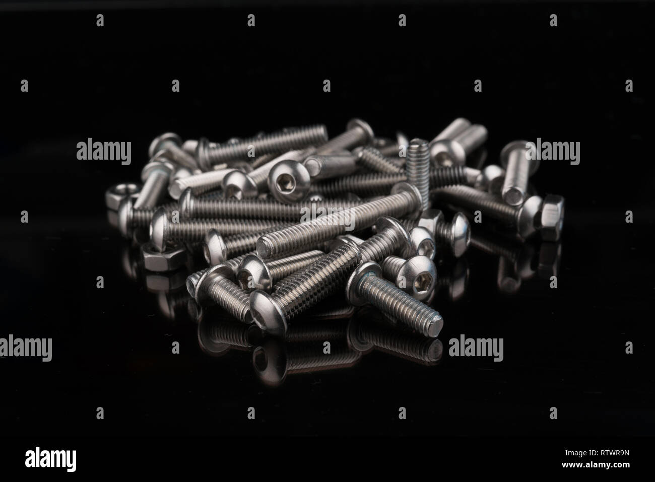 Screw and bolts on black background Stock Photo - Alamy