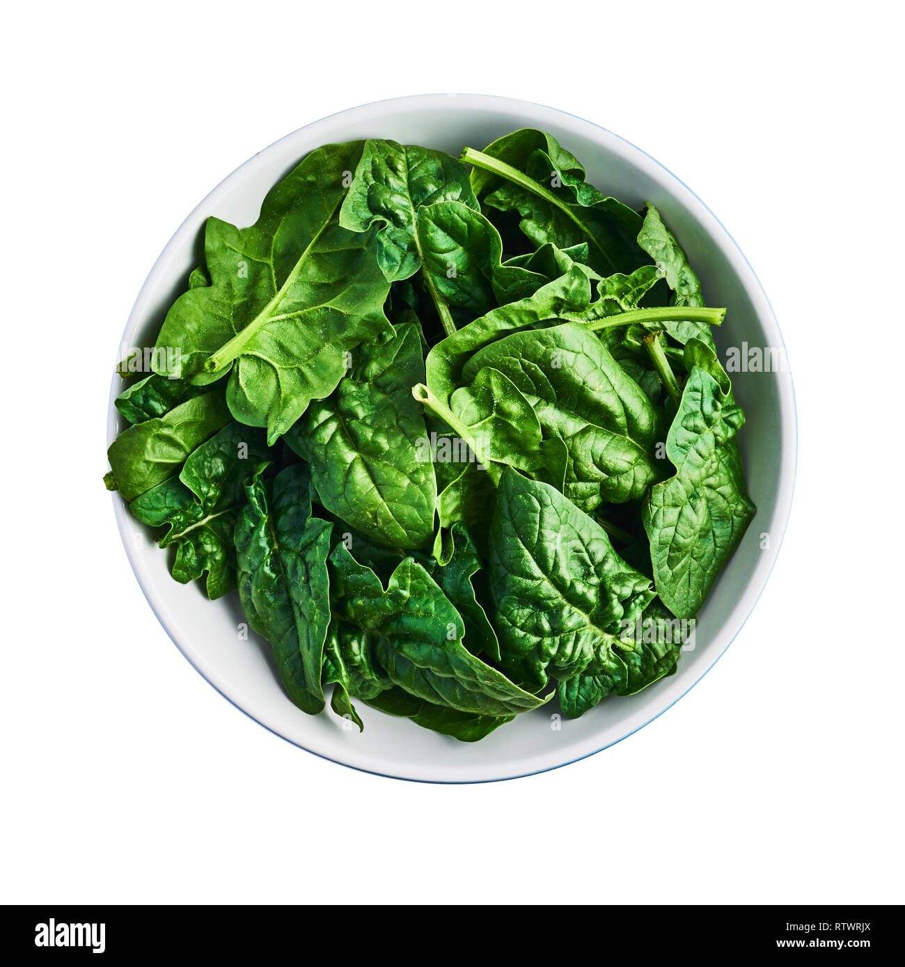 Fresh spinach leaves unwashed in bowl isolated on white background. Top ...