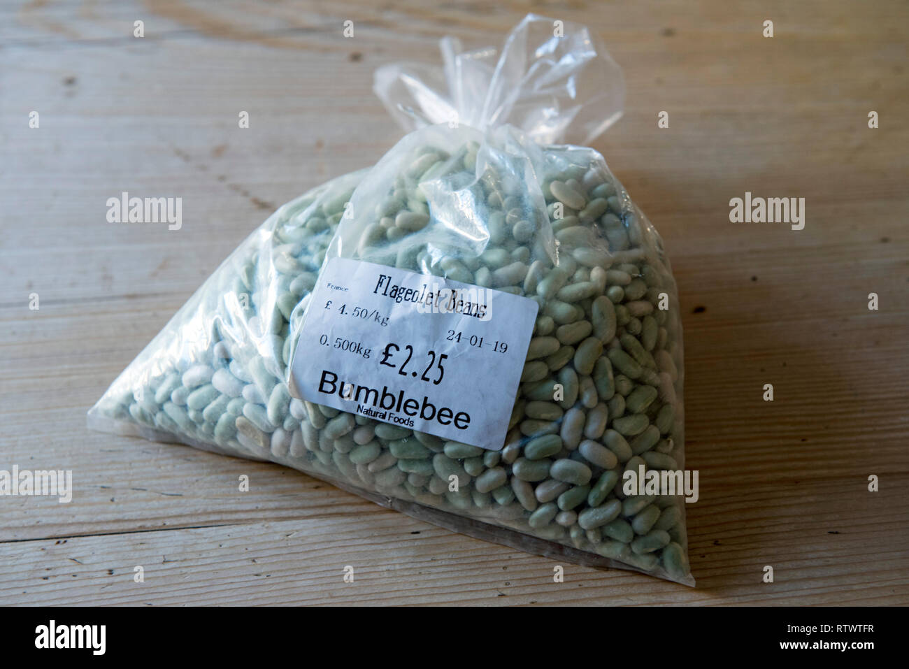 Bag of Flageolet Beans with shop label in half light on wooden kitchen ...