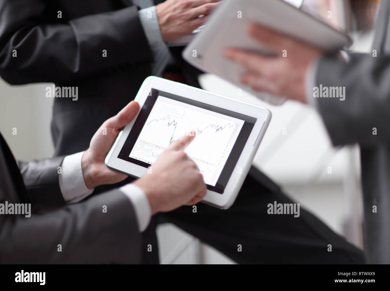 close up.businessmens discuss schedule of sales through the tablet ...