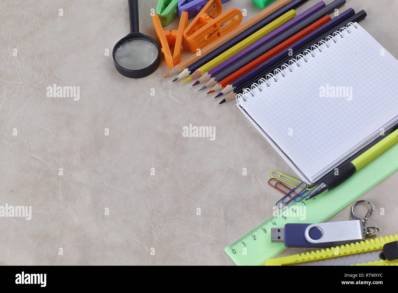 Notepad for taking notes and school supplies on a paper background ...