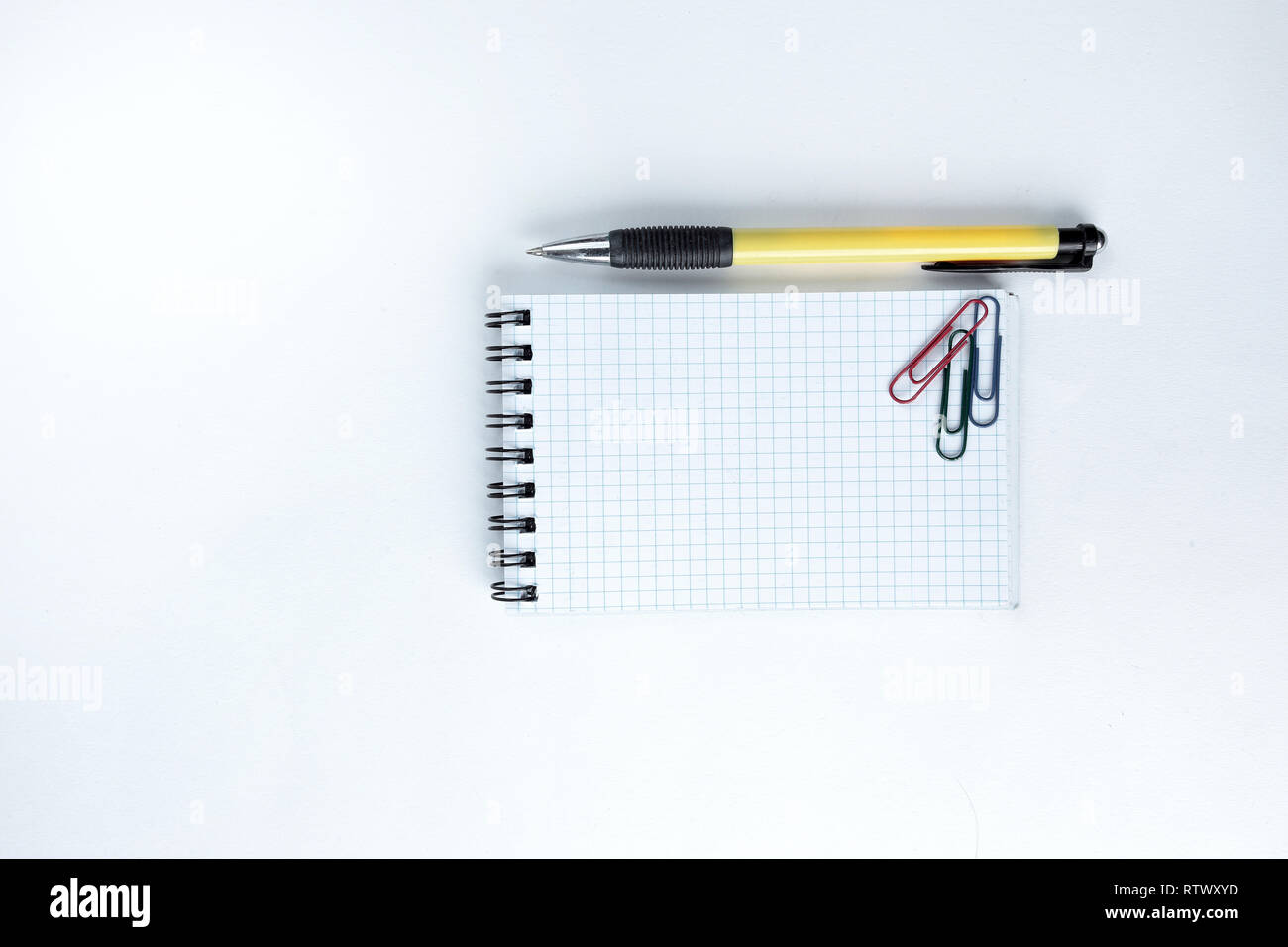Notepad, pen and paper clip on white background .photo with copy space ...