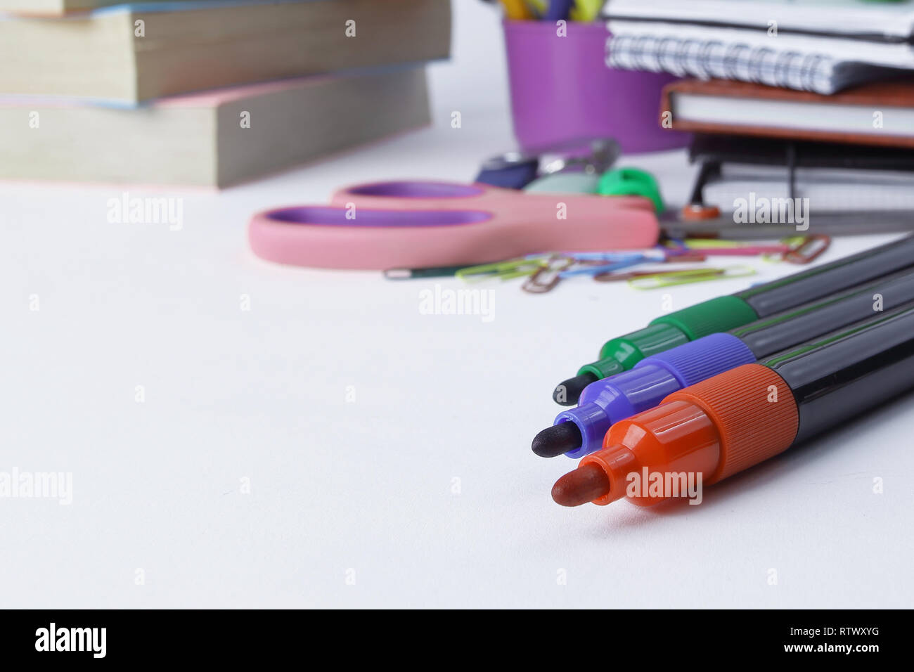 colored markers and school supplies on a white background .concept of ...