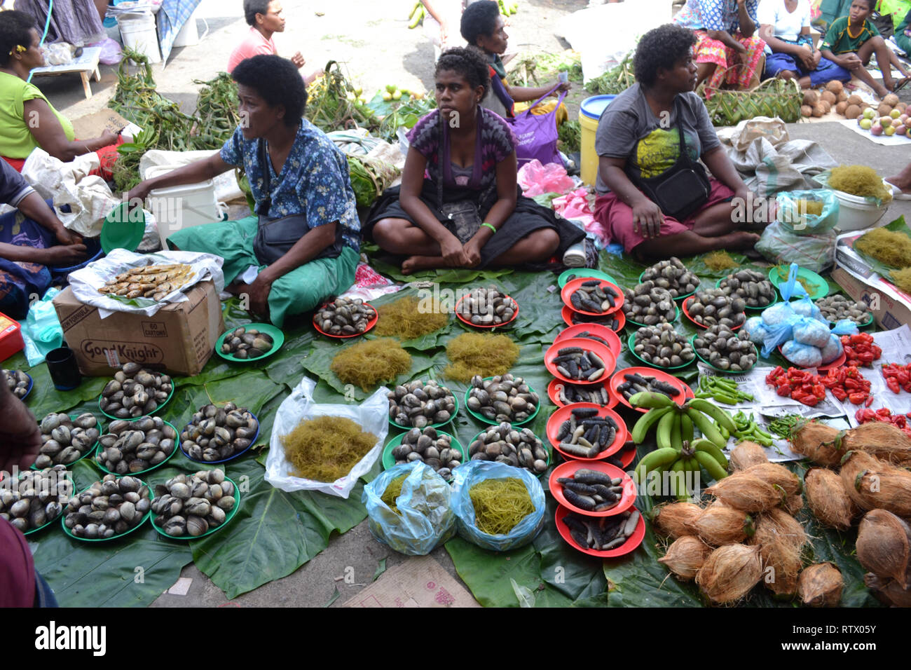 Fijian women sell clams, seafood and fruits in the Suva market, Suva ...