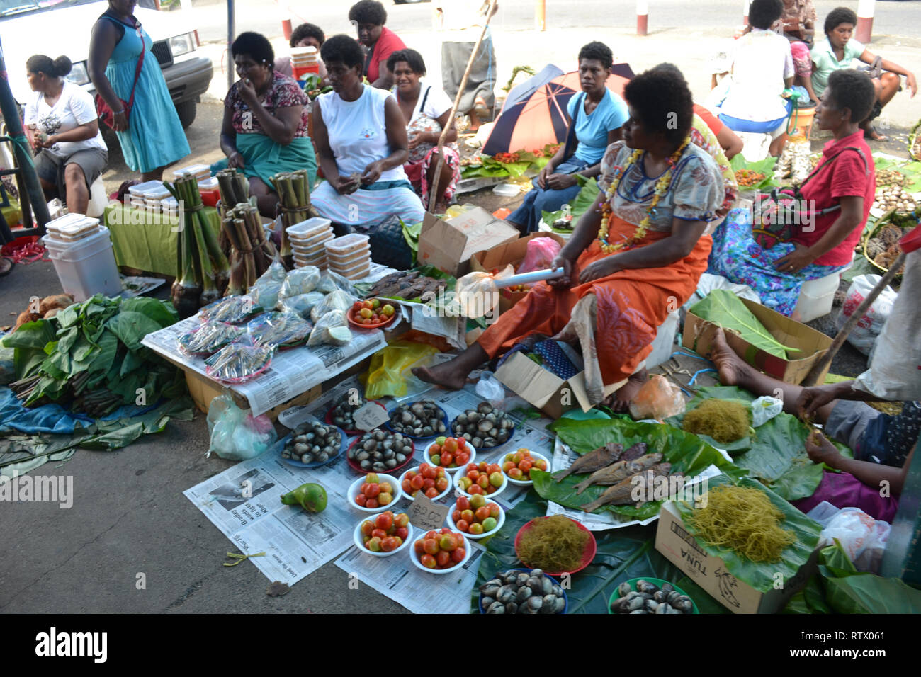 Fijian women sell clams, seafood and fruits in the Suva market, Suva ...