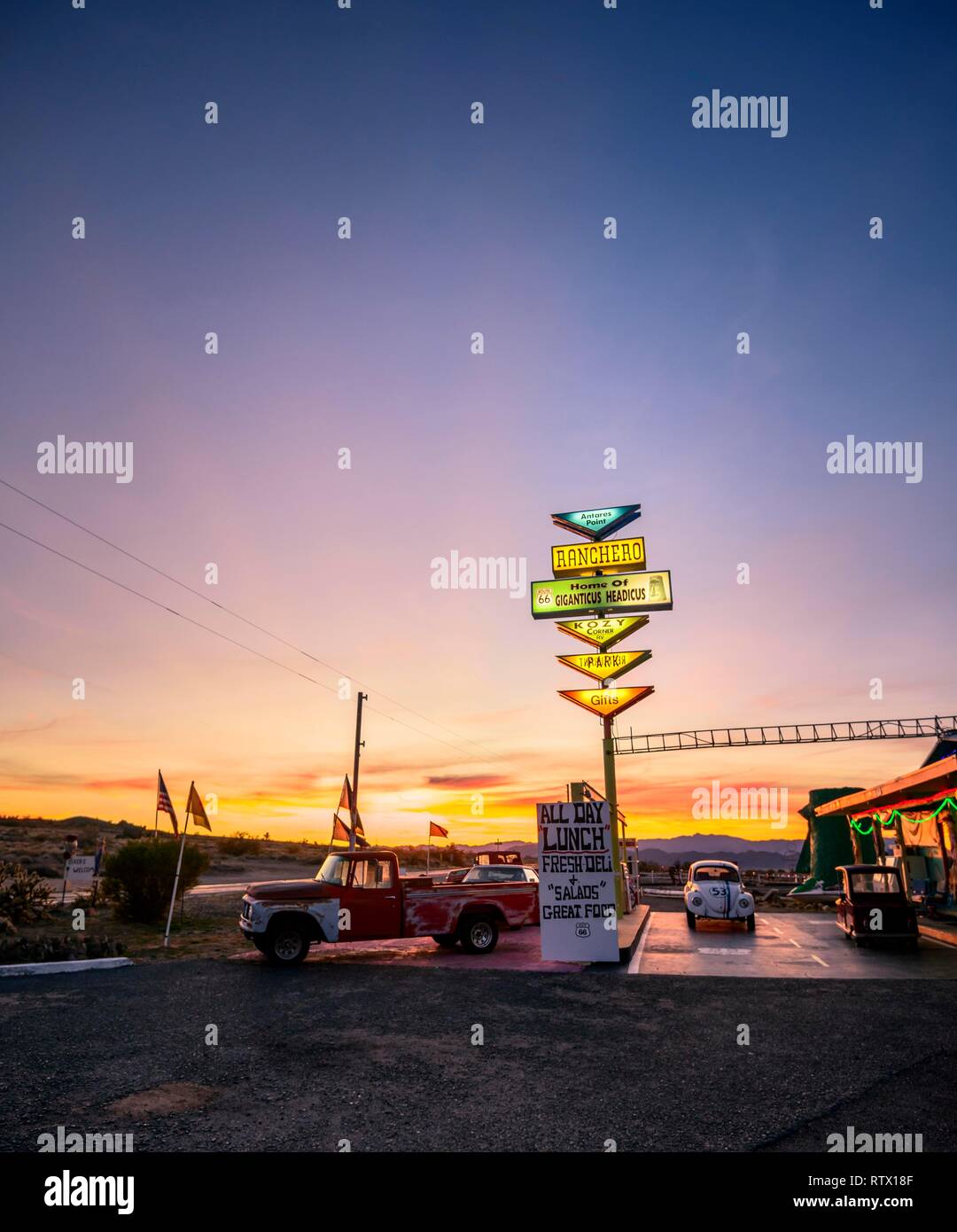 Historic rest stop and gas station with vintage cars, at sunset ...