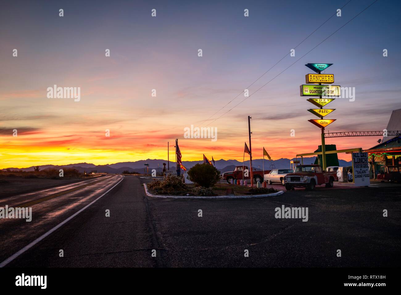 Historic rest stop and gas station with vintage cars, at sunset ...