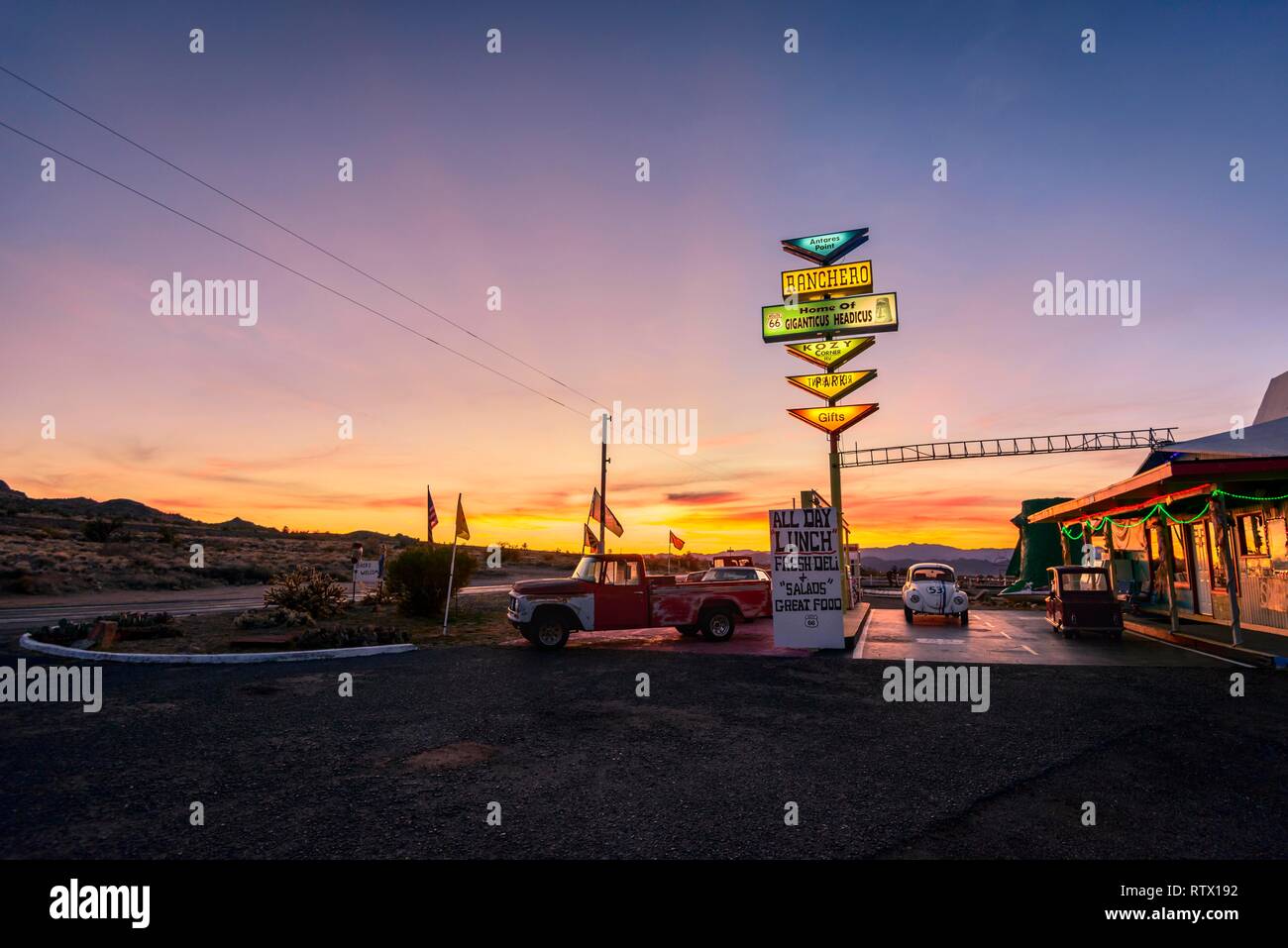 Historic rest stop and gas station with vintage cars, at sunset ...