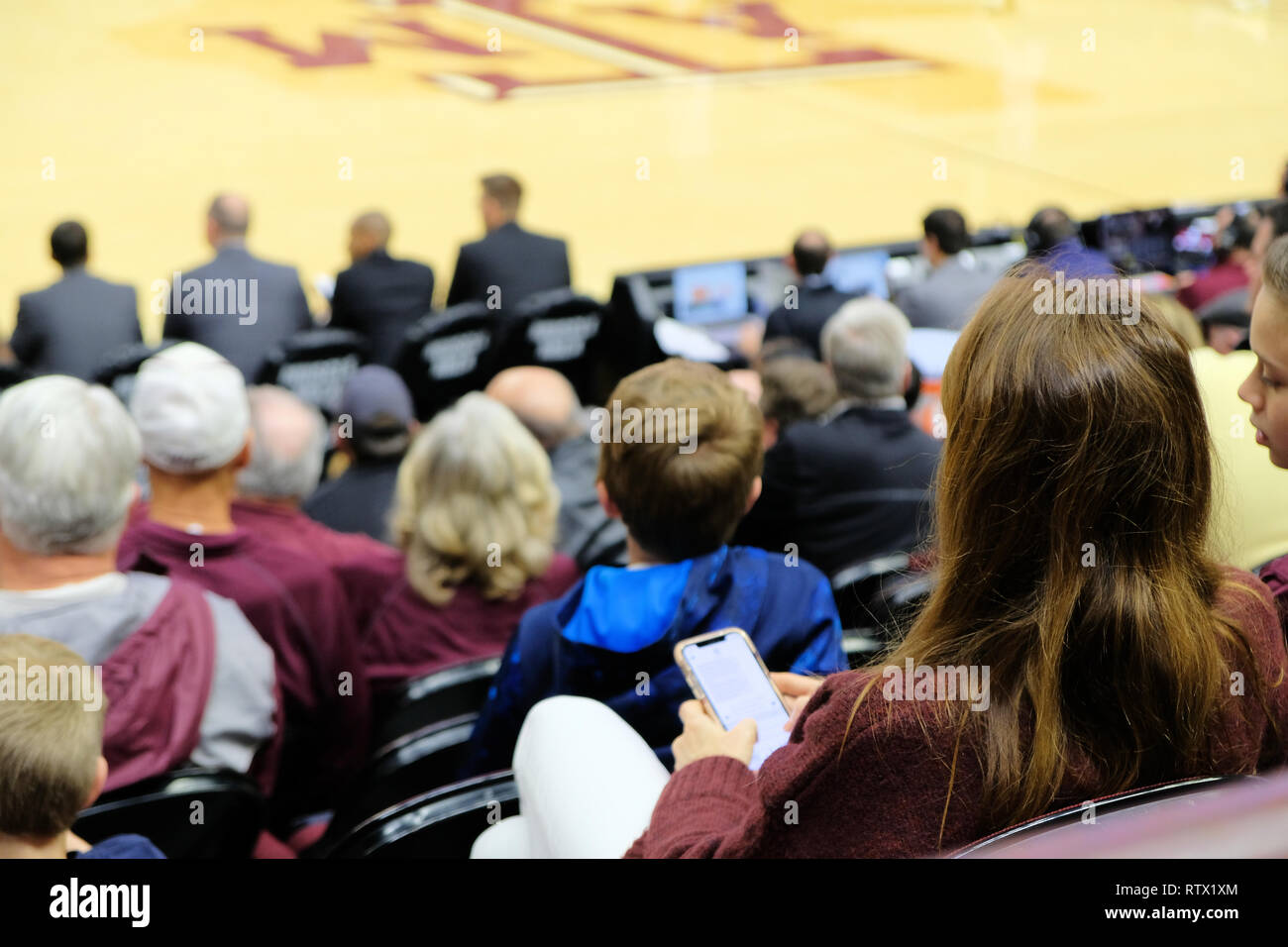Family of fans watching arena floor during an NCAA basketball game at ...