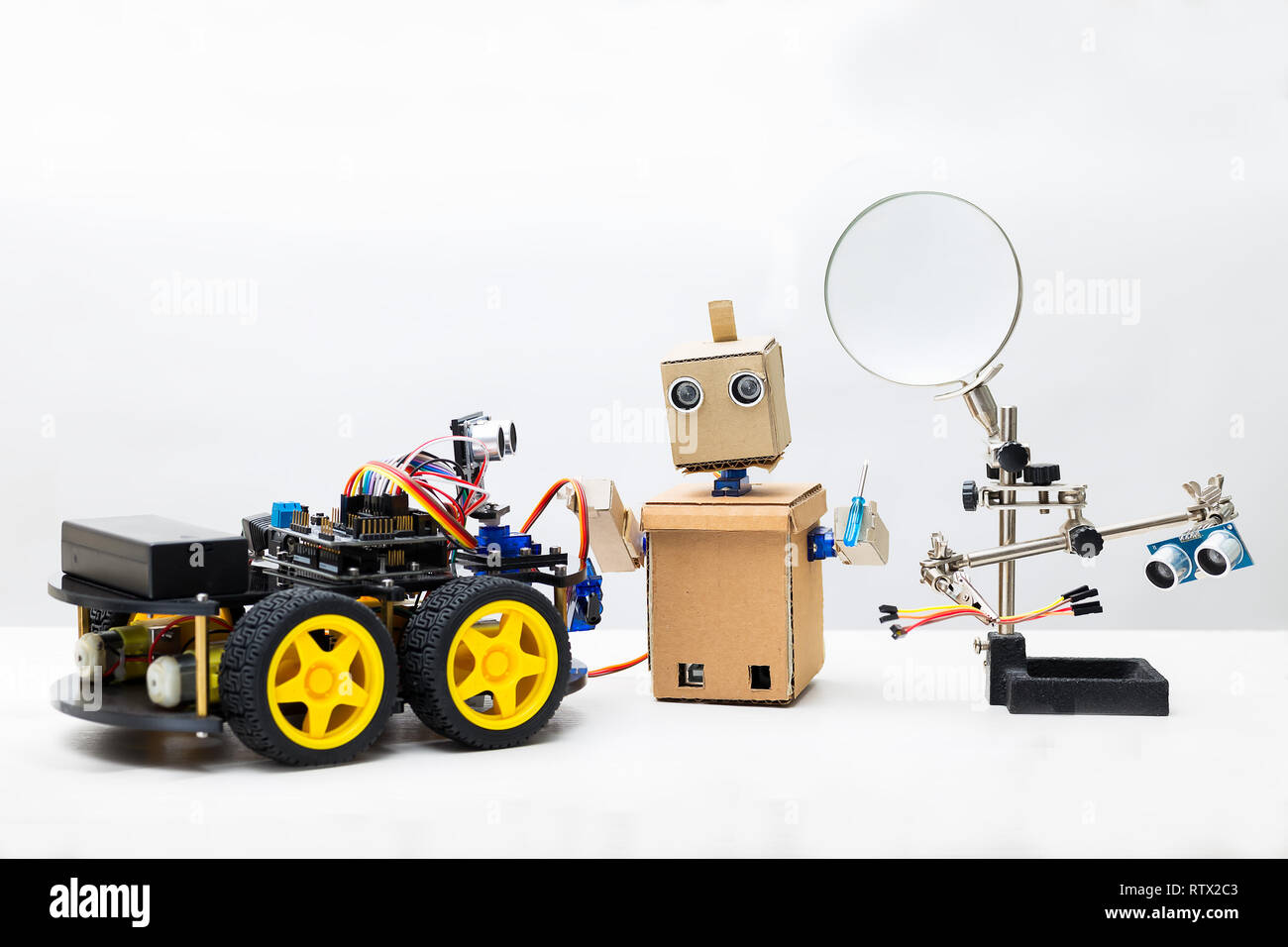 Two robots and parts for assembling a robot on a white background Stock ...