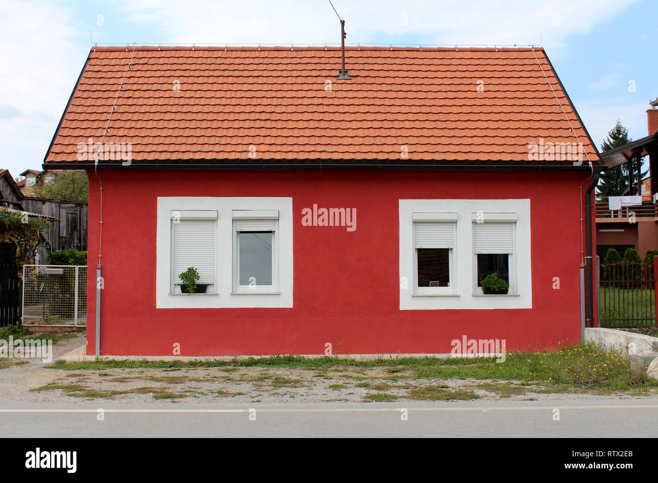 Completely renovated small suburban family house with new windows and roof tiles surrounded with ...