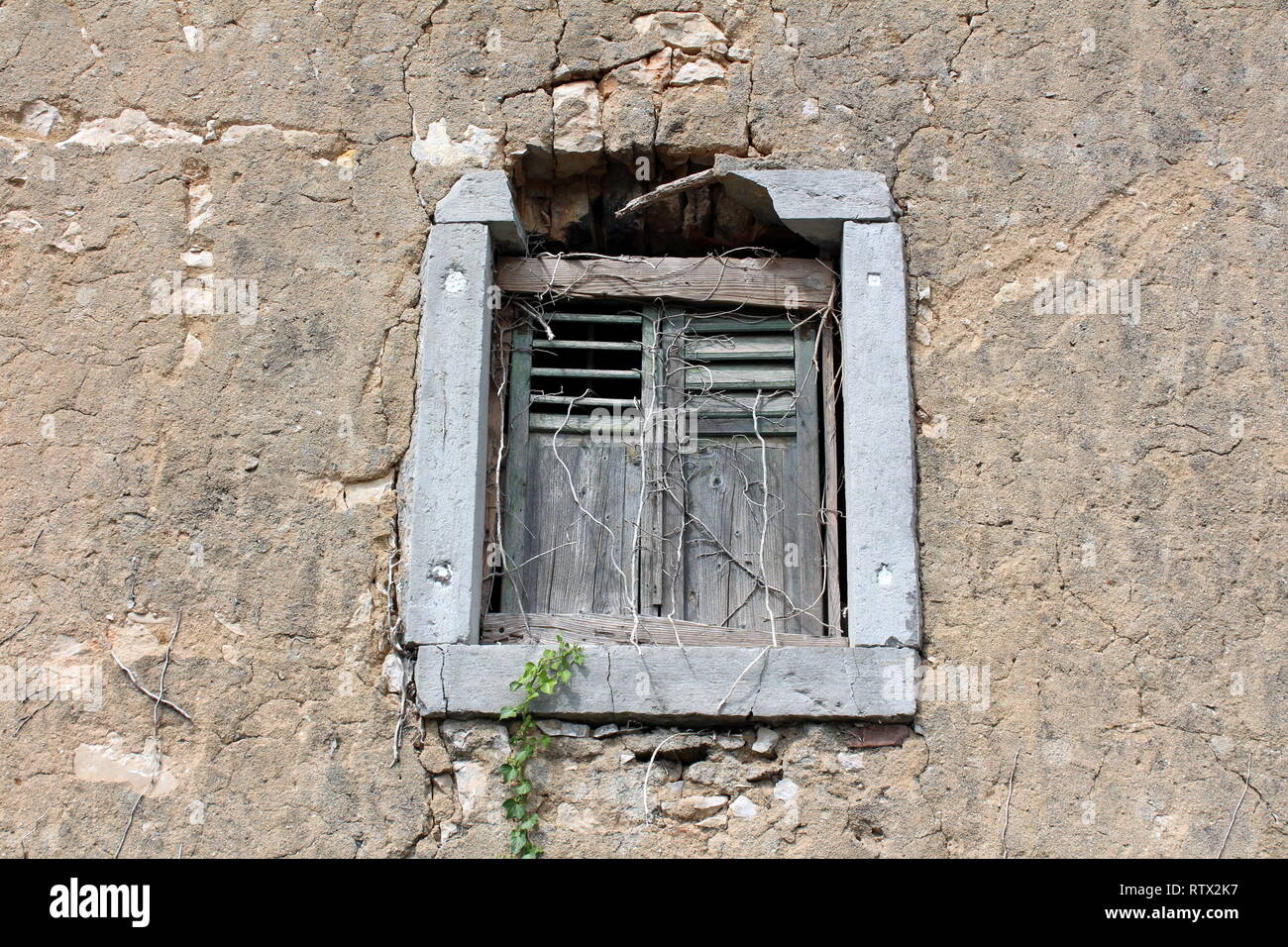Destroyed broken old wooden window with closed window blinds on ...