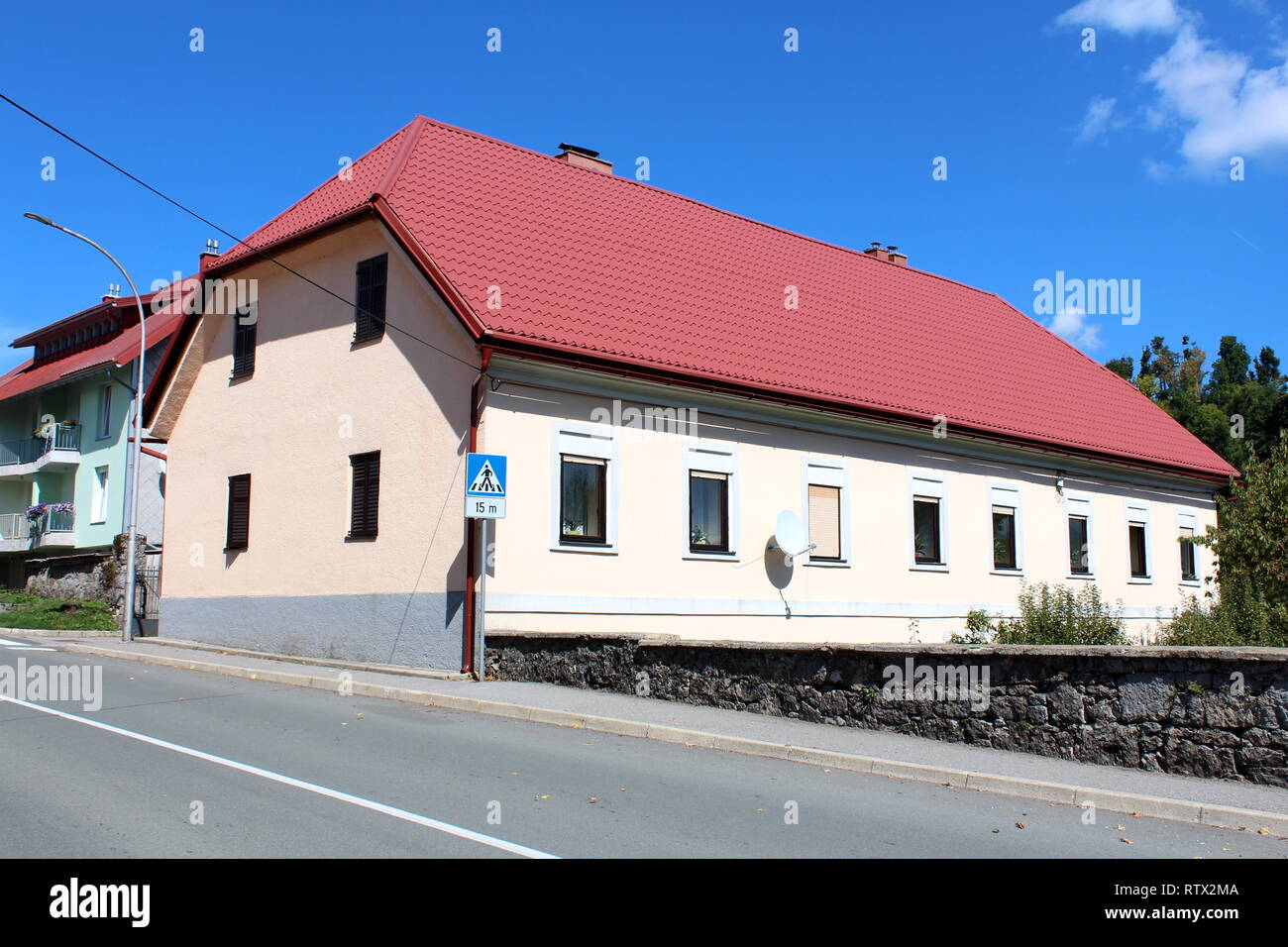Elongated ground level family house with multiple windows in a row and ...
