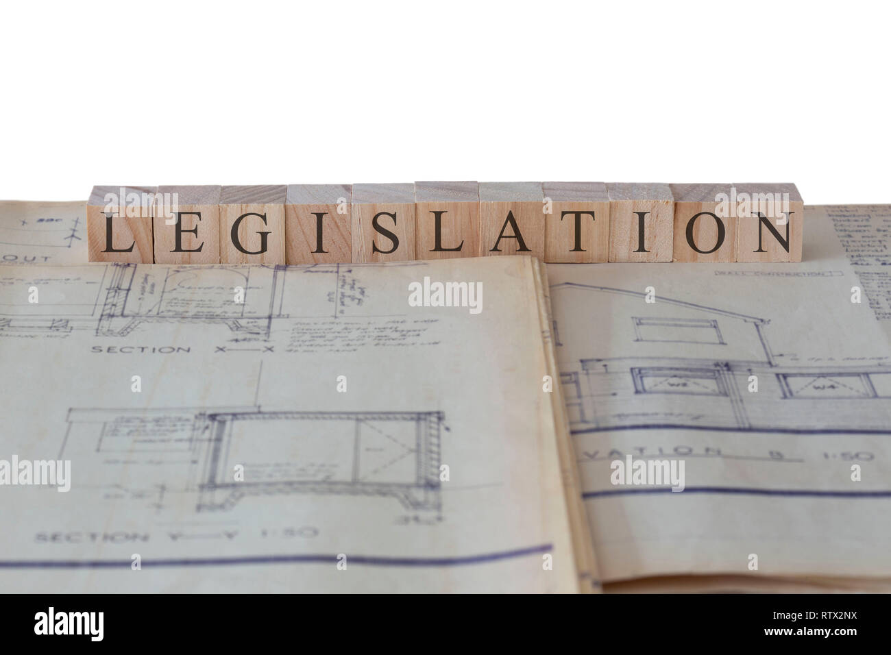 Legislation written on wooden blocks on house extension building plans ...