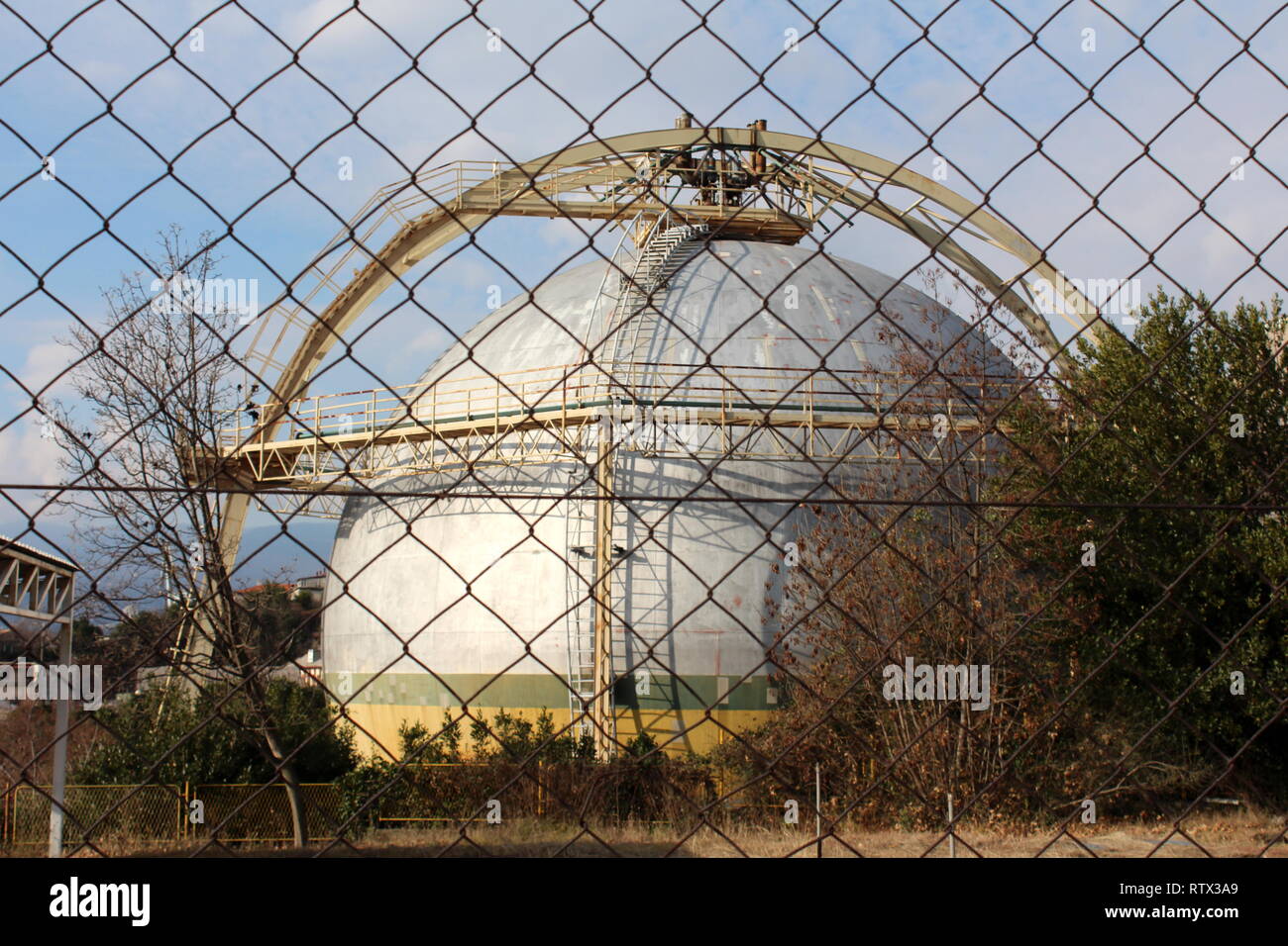 Large sphere storage structure with metal steps on one side surrounded ...