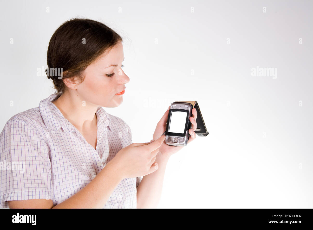 pretty girl with a smartphone on white and grey background Stock Photo ...