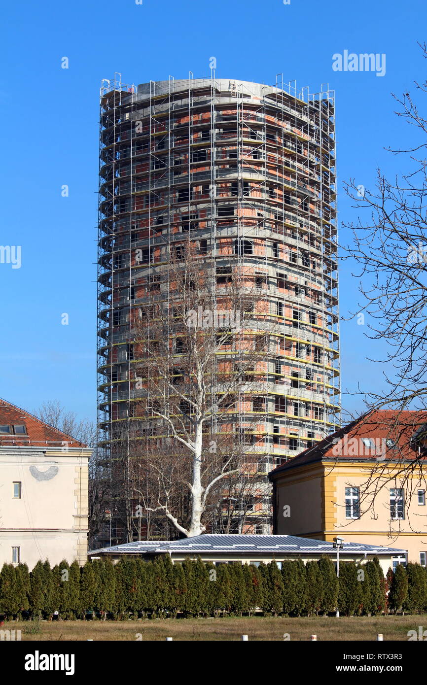 New round tower building under construction completely surrounded with ...