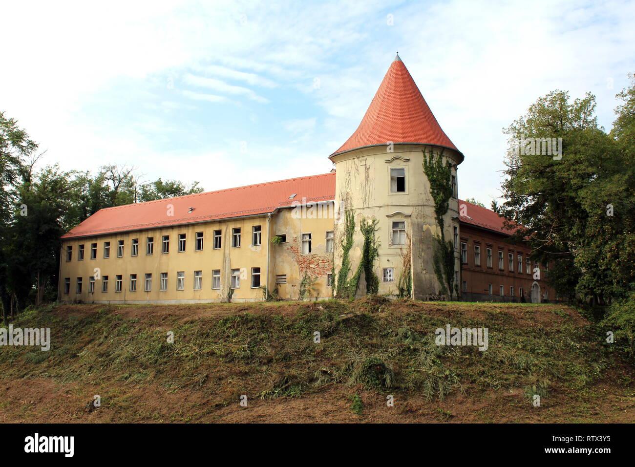 Old abandoned castle with dilapidated cracked facade and broken windows ...