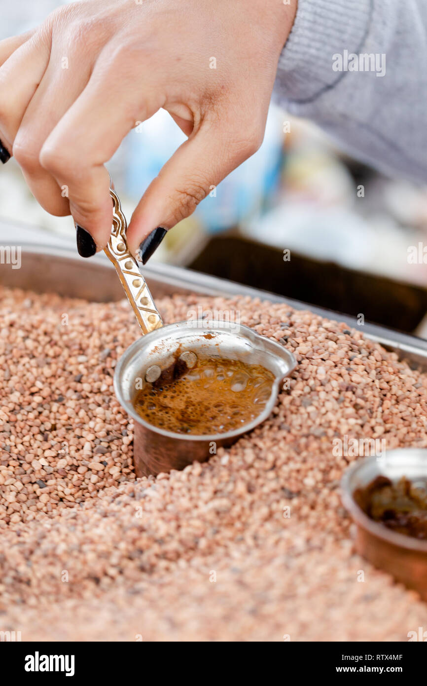 Traditional Turkish, Arabic coffee brewed in small copper cups in hot ...
