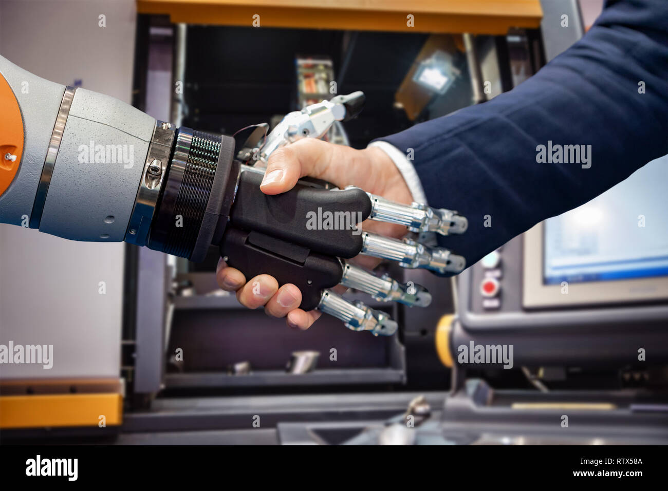 Hand of a businessman shaking hands with a Android robot. The concept ...