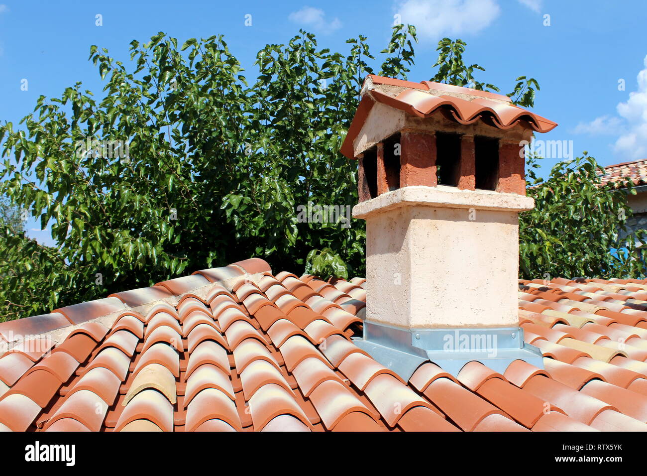 Single chimney covered with same roof tiles in various decorative shade ...