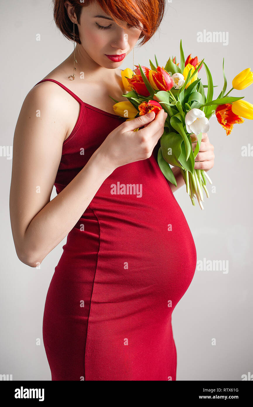 Pregnant woman in red dress hi-res stock photography and images - Alamy