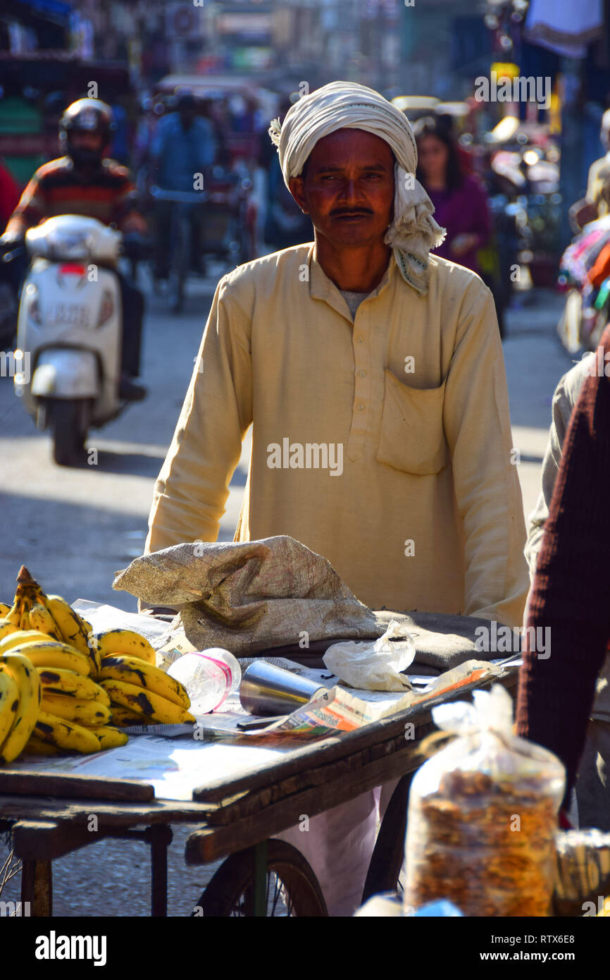 Indian Man with turban pushing cart through streets of Delhi Stock ...