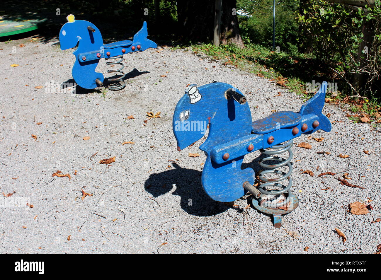 Two vintage retro old outdoor public playground equipment in shape of ...