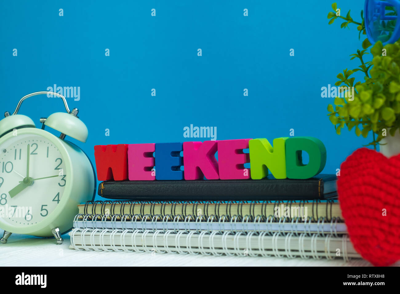WEEKEND letters text and notebook paper, alarm clock and little ...